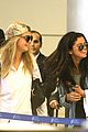 Selena Gomez Smells The Roses at LAX Airport with Cara Delevingne ...