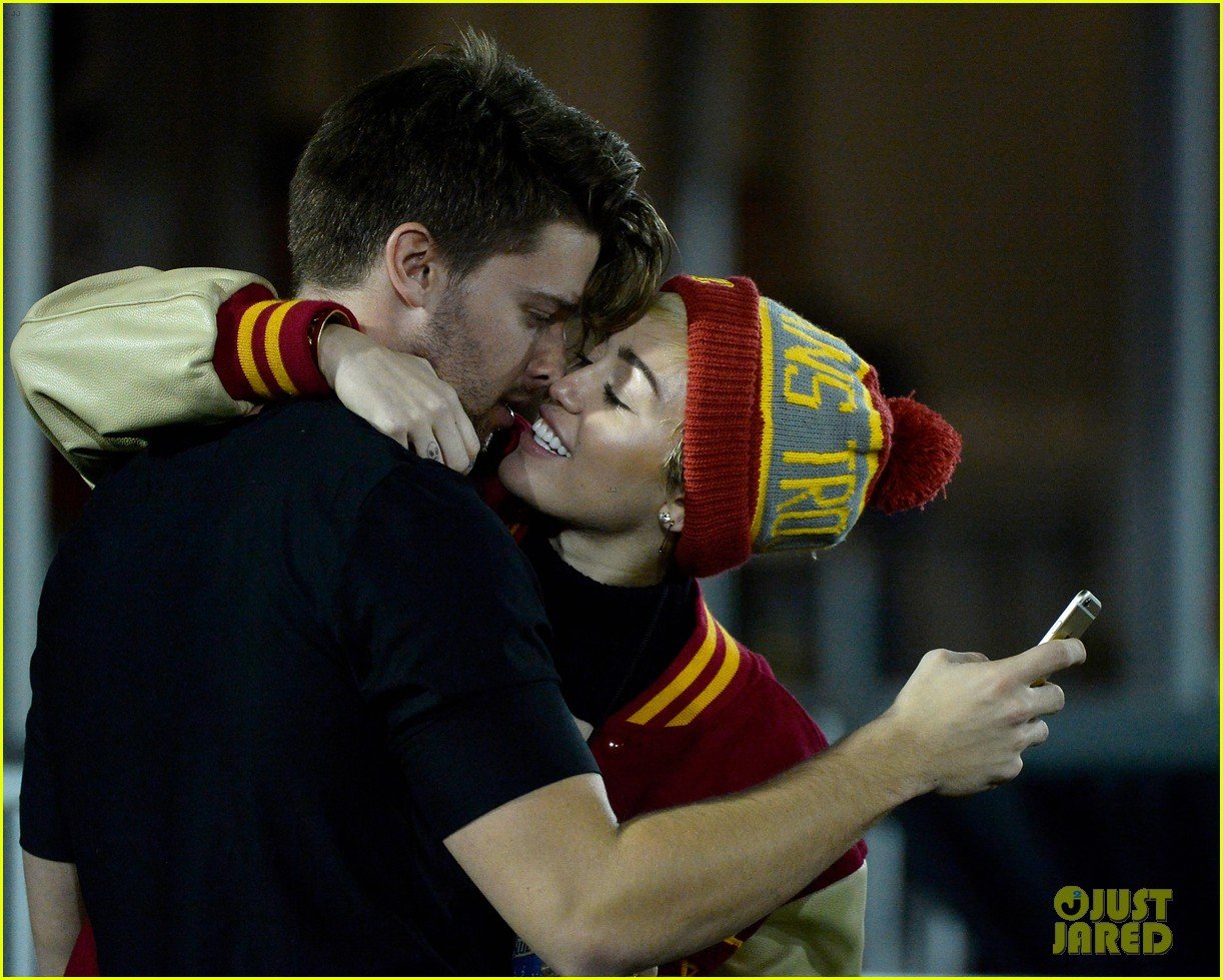 Miley Cyrus & Patrick Schwarzenegger Kiss at USC Football Game - See ...