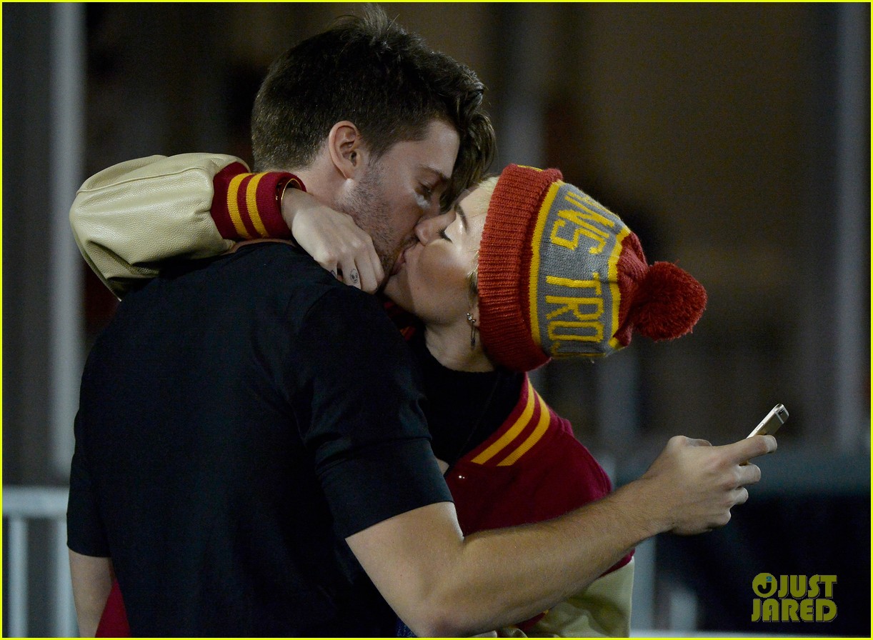 Miley Cyrus & Patrick Schwarzenegger Kiss at USC Football Game - See ...