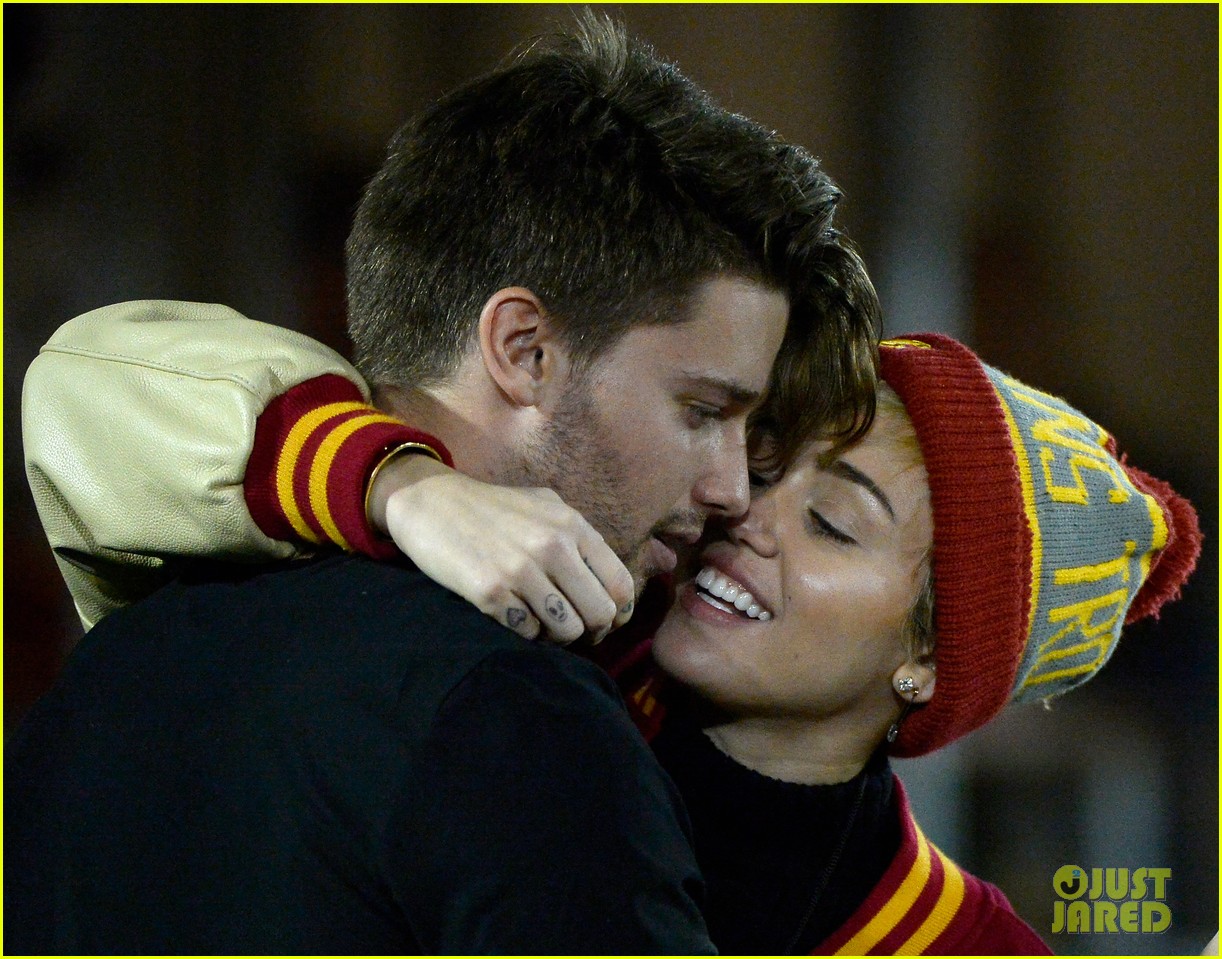 Miley Cyrus & Patrick Schwarzenegger Kiss at USC Football Game - See ...