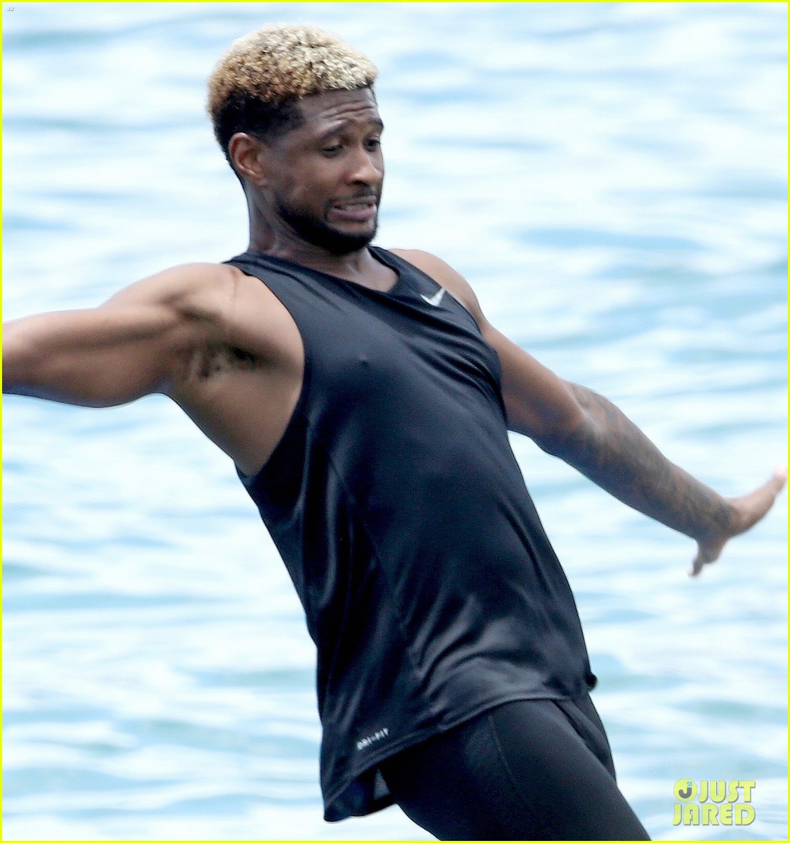 Usher Stays Clothed While Paddle Boarding, Goes Shirtless on the Beach ...