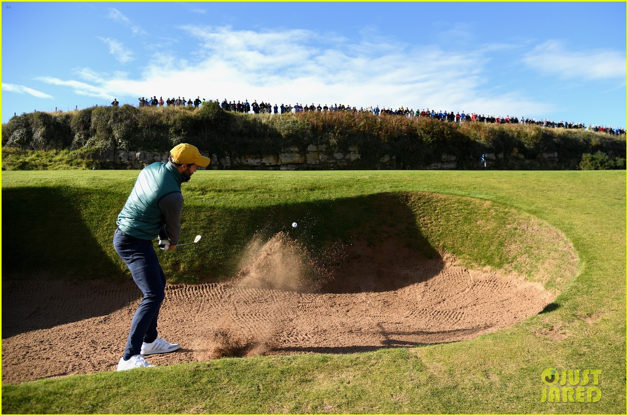 Jamie Dornan Hits Out of the Bunker During Day Three of Golf Tournament ...