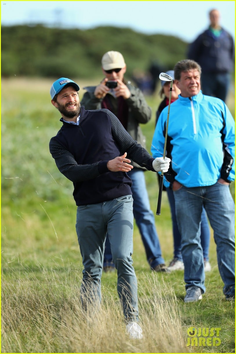 Jamie Dornan Hits Out of the Bunker During Day Three of Golf Tournament ...