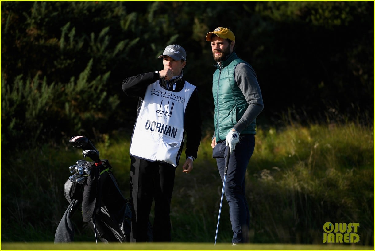 Jamie Dornan Hits Out of the Bunker During Day Three of Golf Tournament ...