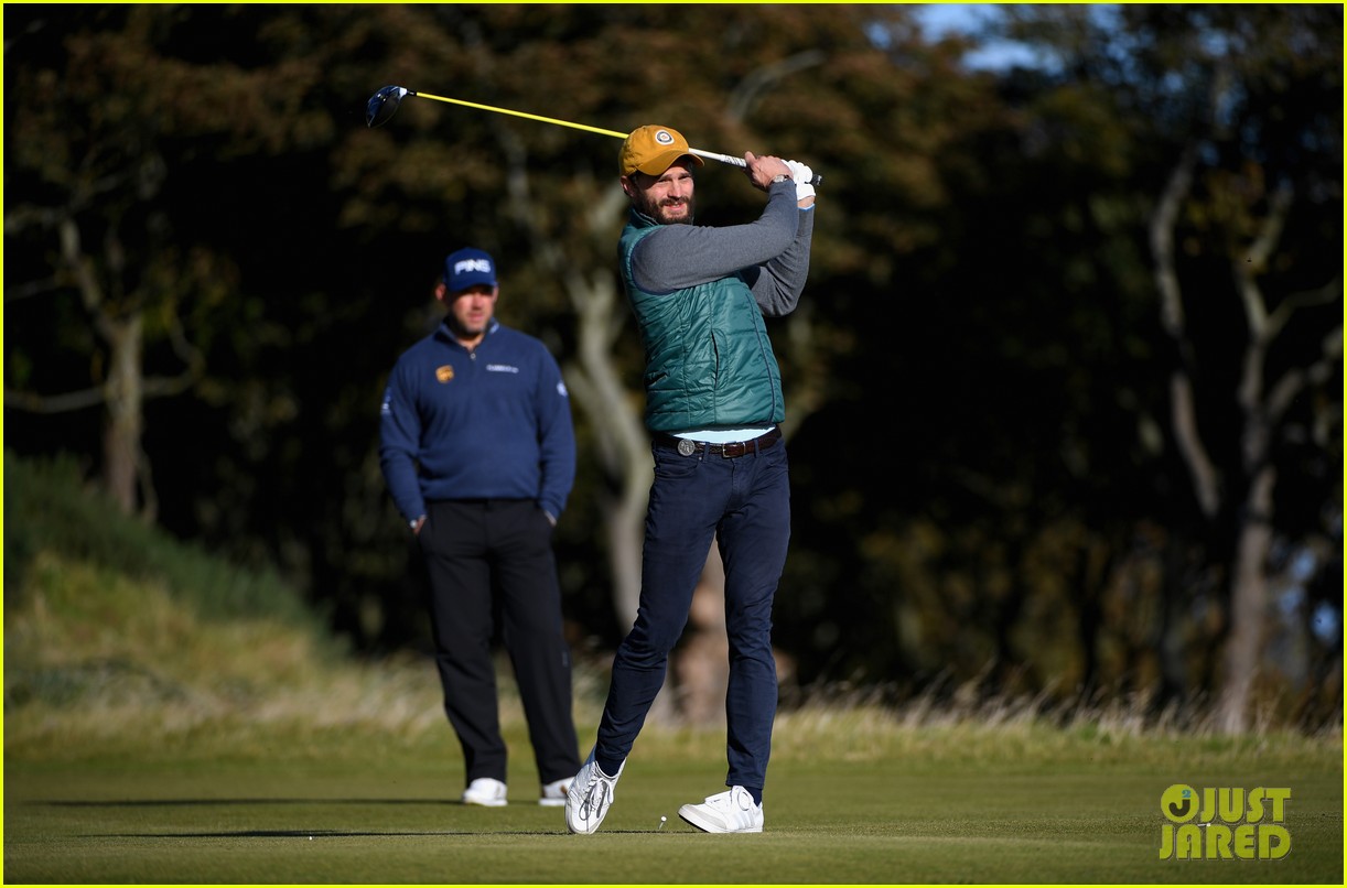 Jamie Dornan Hits Out of the Bunker During Day Three of Golf Tournament ...