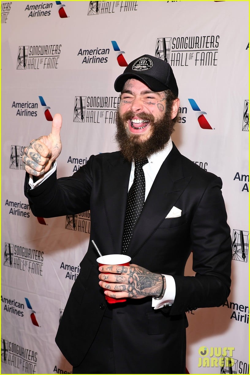 Post Malone Suits Up, Arrives With a Drink in Hand for Songwriters Hall ...