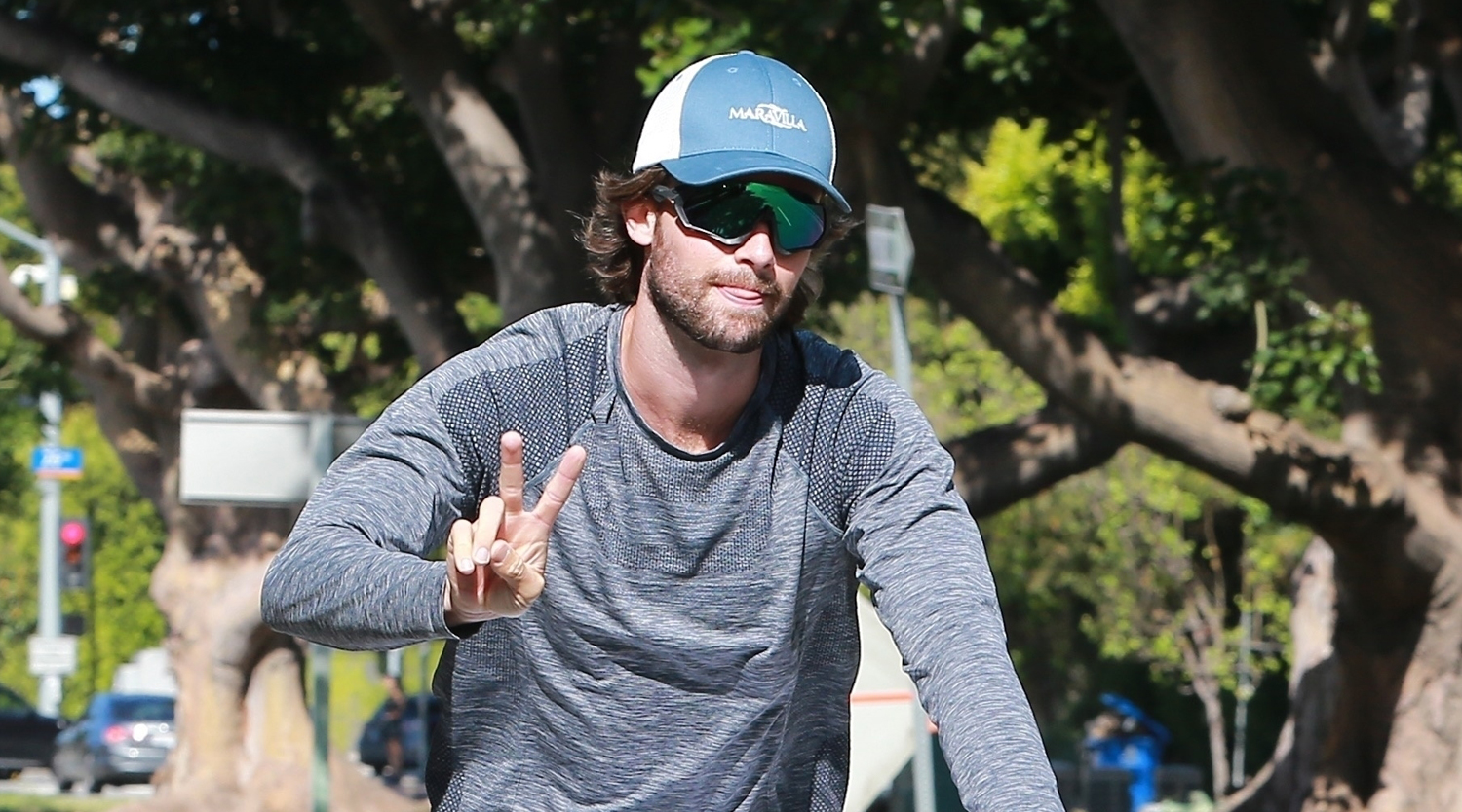 Patrick Schwarzenegger Throws Up the Peace Sign on Bike Ride | Patrick ...